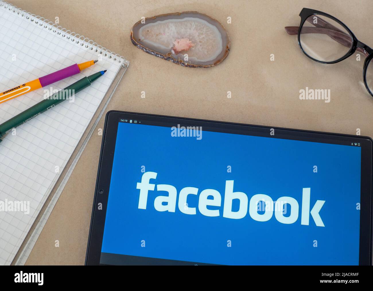 In this photo illustration, a Facebook logo seen displayed on a tablet ...