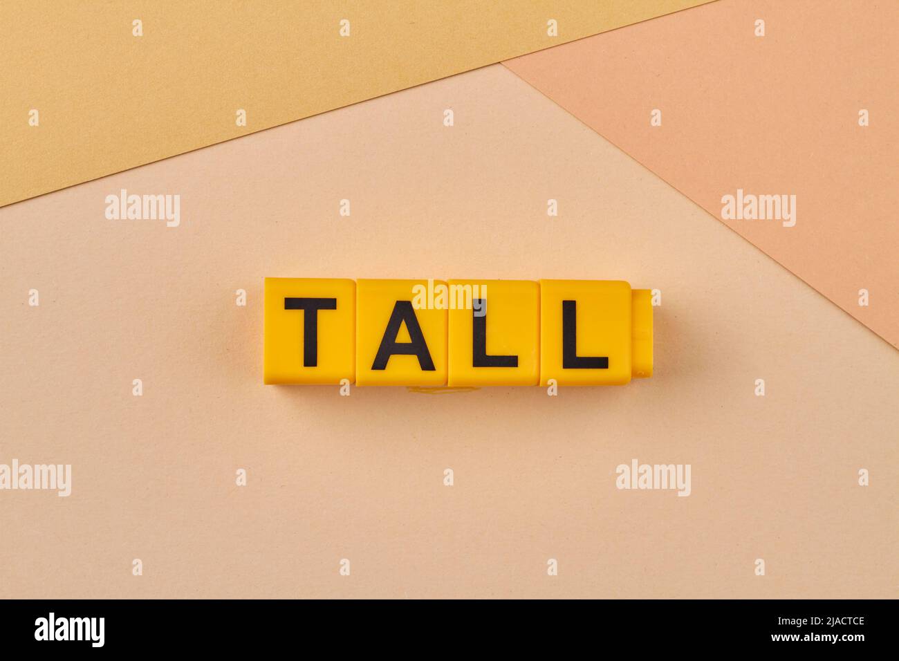 Word tall written on yellow blocks against color background. Height ...