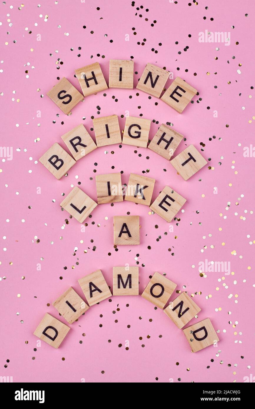 Text shine bright like a diamond written on wooden blocks. Top view and ...