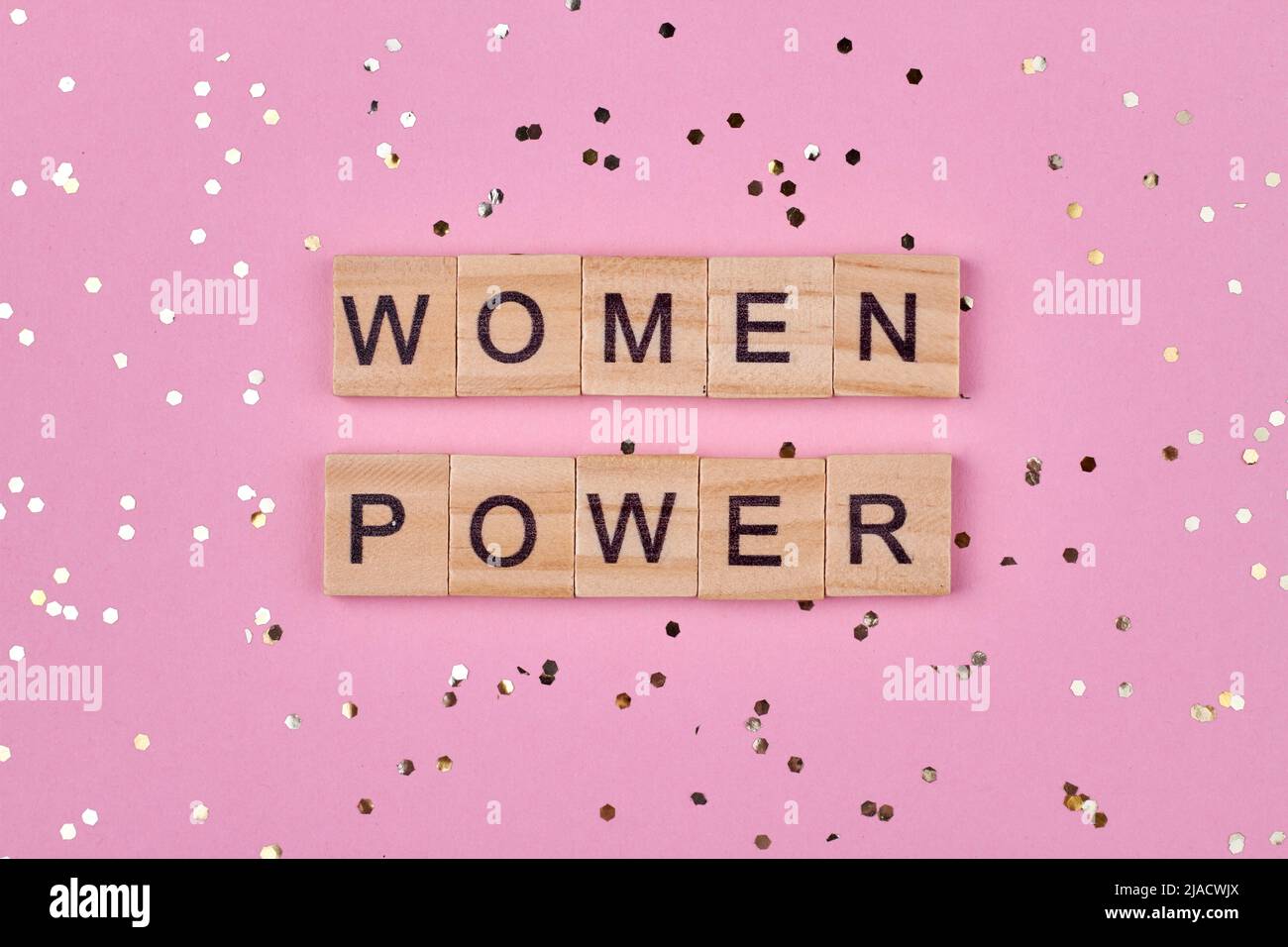 Women power inscription on wooden cubes against color background ...