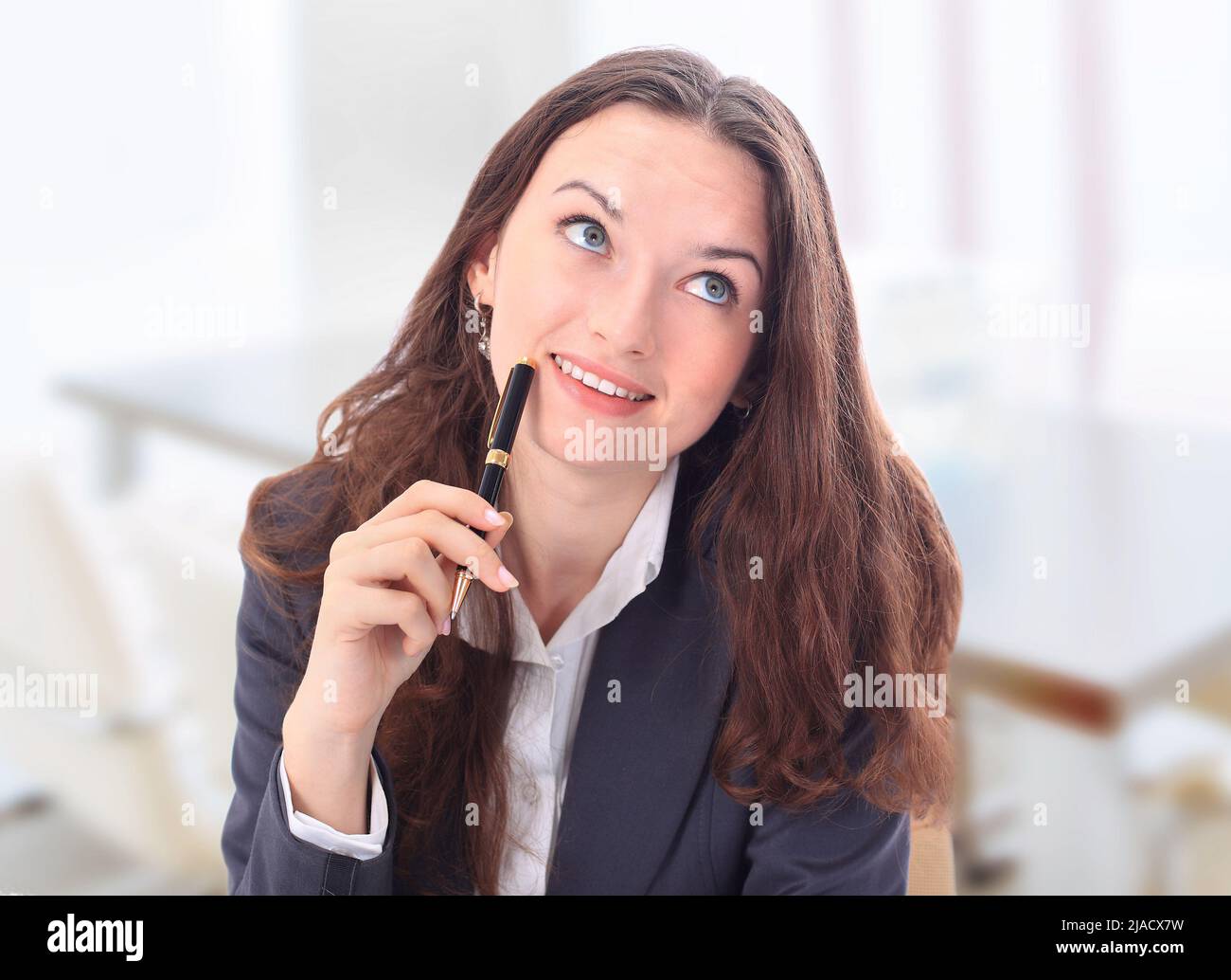 Business woman sitting in the office and thoughtful look in the ...