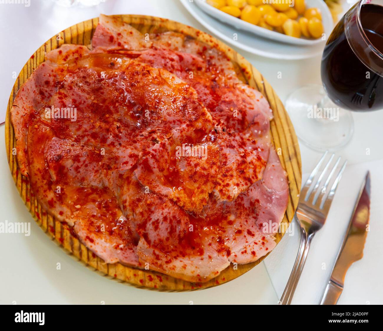 Slices of lacon galician boiled pig ham served at plate Stock Photo - Alamy