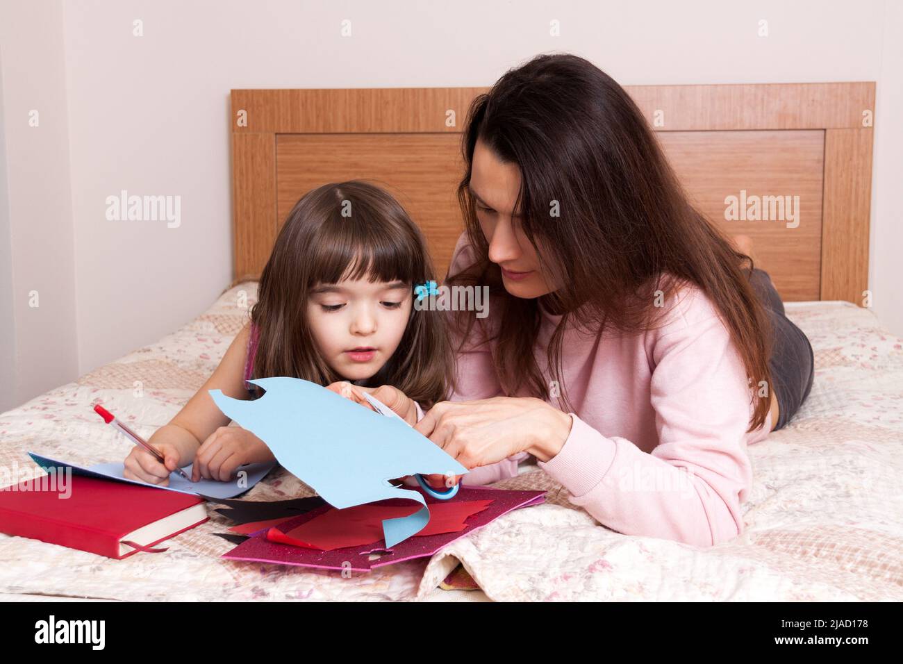 Mom with the daughter reading together Stock Photo - Alamy