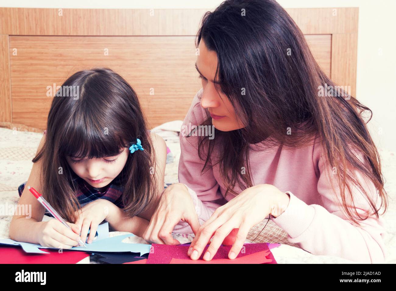 Mom with the daughter reading together Stock Photo - Alamy
