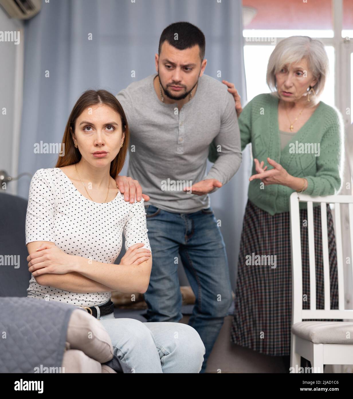 Domestic quarrel - husband and mother try to calm crying wife Stock ...