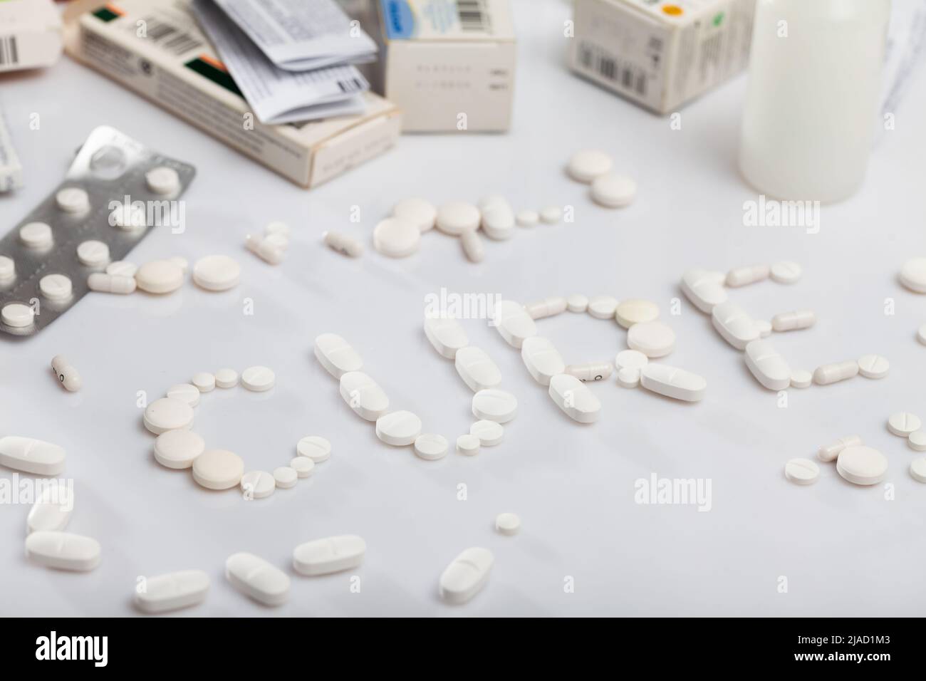 Word CURE lined with tablets Stock Photo - Alamy