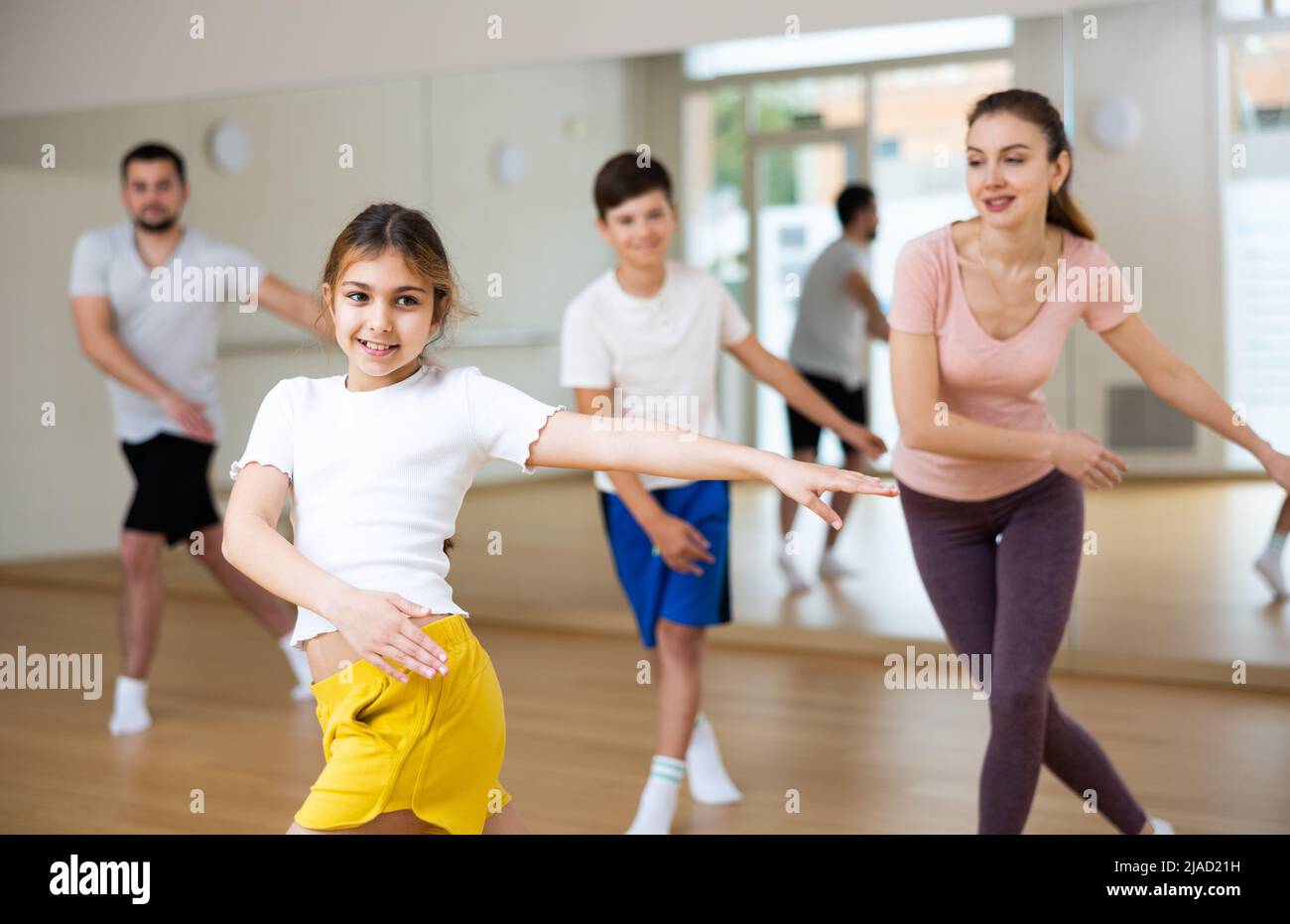 Girl exercising during family dance class Stock Photo - Alamy