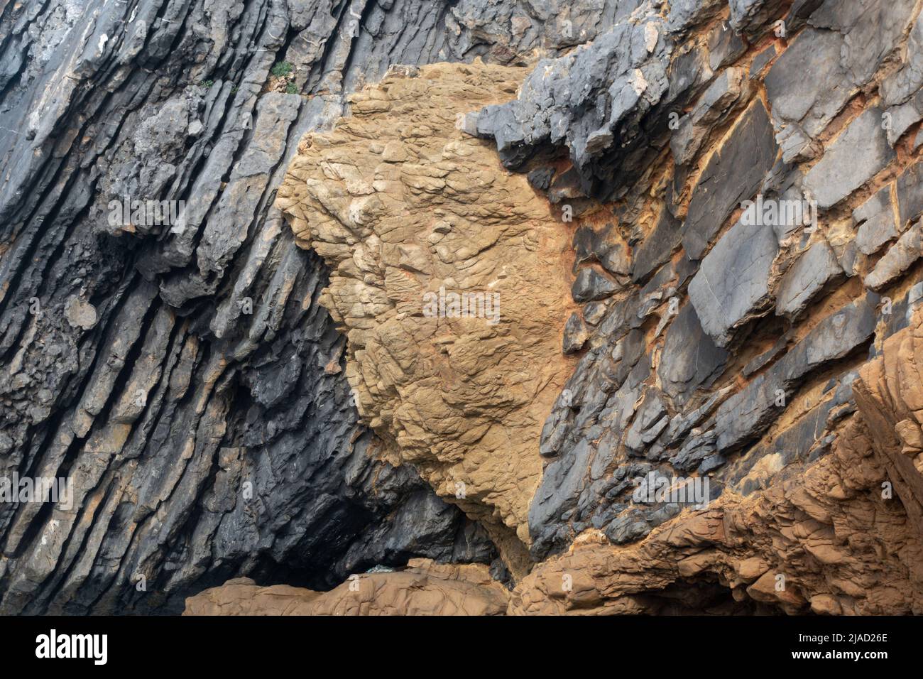 Black and red layers of fragmented rock in geological formation on the ...