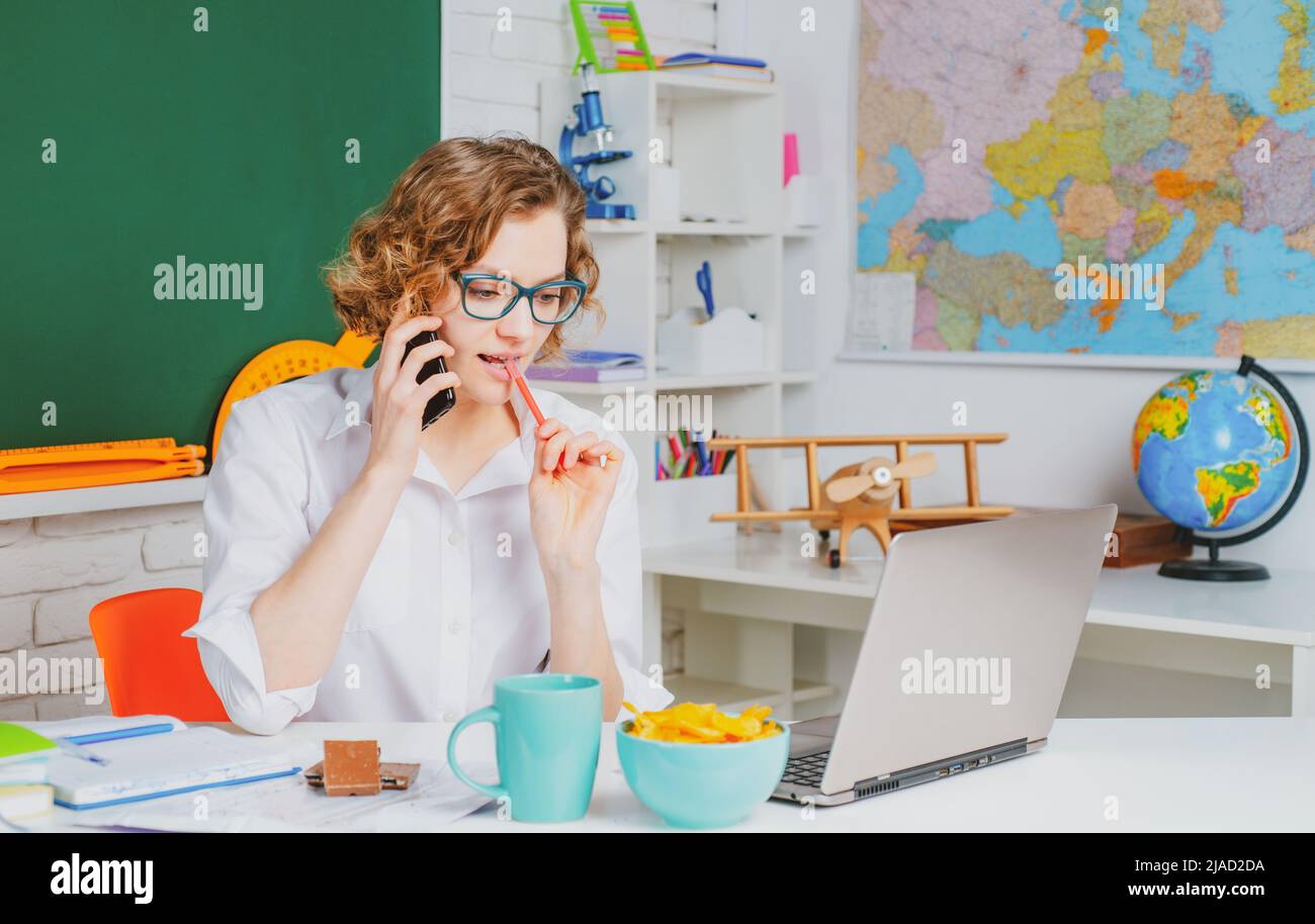Learn with fun. Funny female teacher with mobile phone use laptop ...