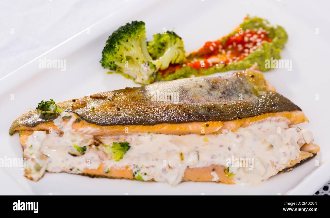 Deliciously steak of fried river trout fillet with broccoli and sause ...