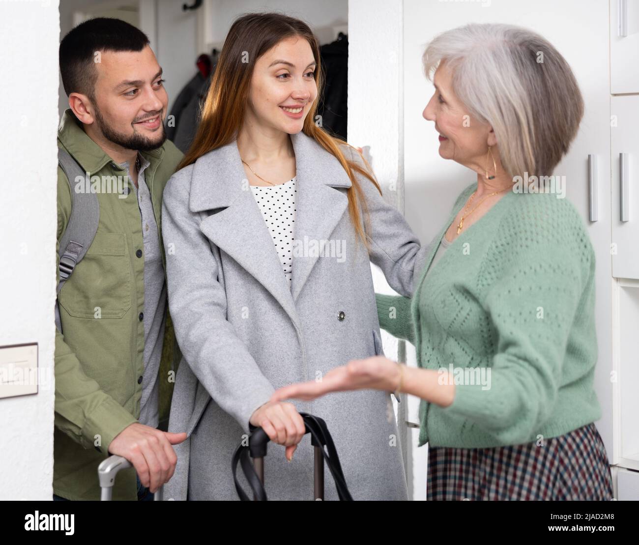 Children coming to visit their elderly mother to parental home Stock ...