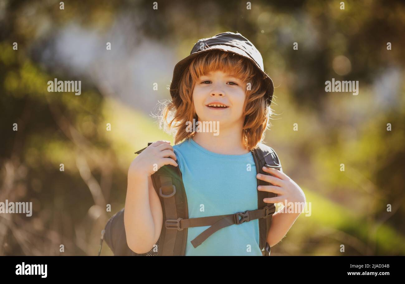 little boy with backpack hiking in scenic mountains. Boy local tourist ...