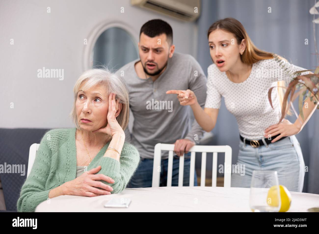 Chagrined senior woman having problems in relationship with couple ...