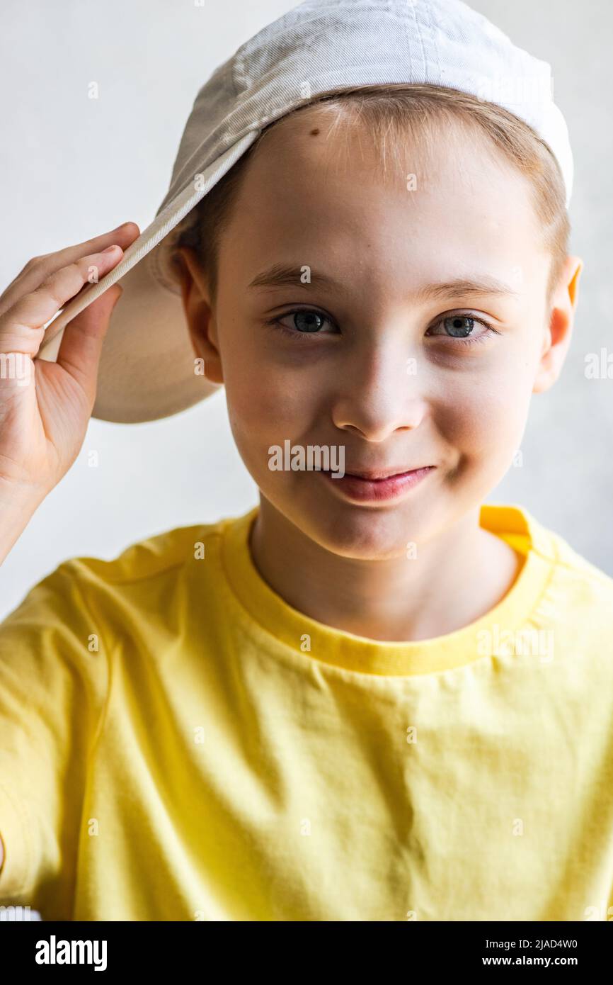 Smiling boy with his hand on his baseball cap Stock Photo - Alamy