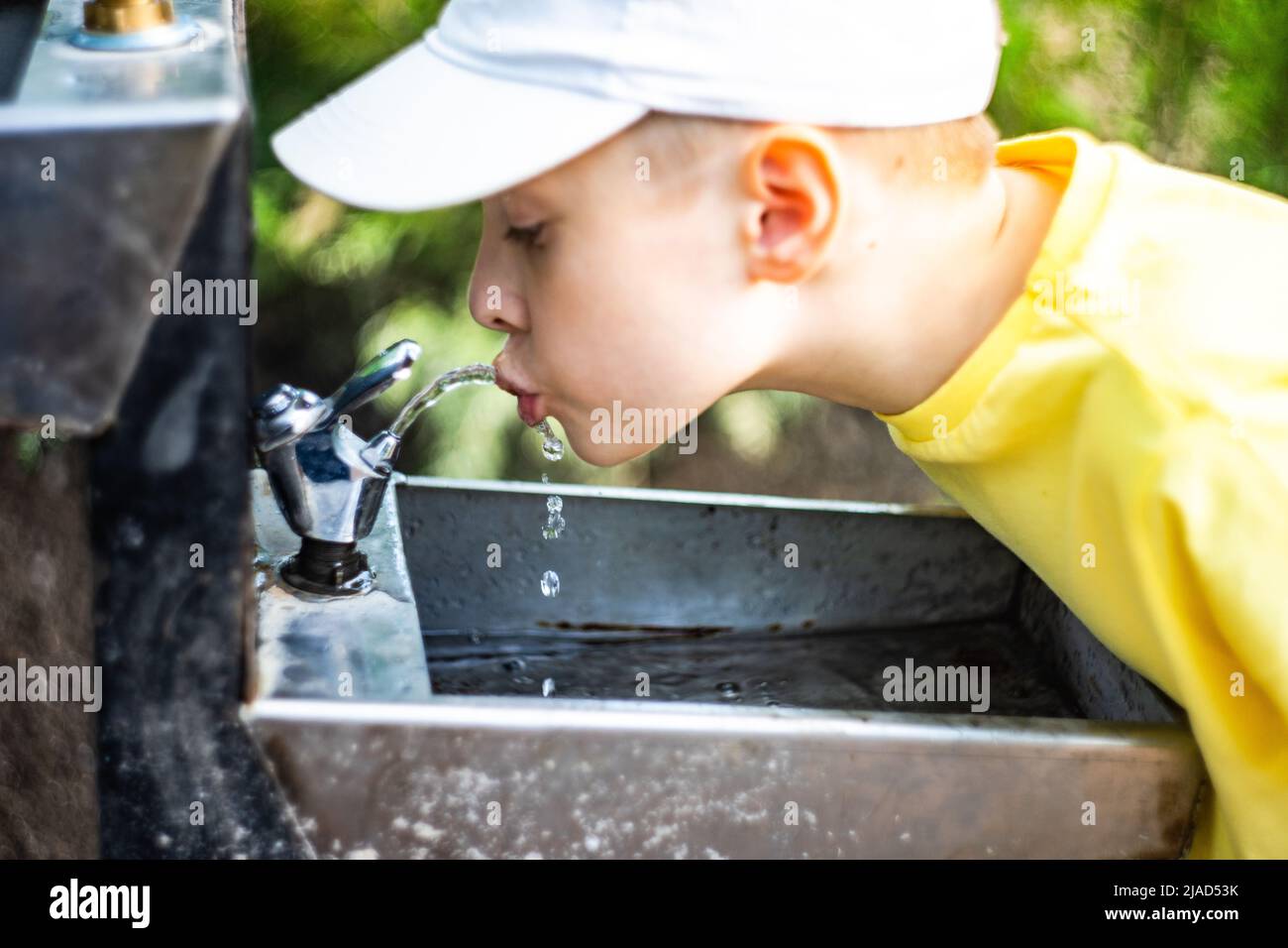 Boy drinking from fountain hi-res stock photography and images - Alamy
