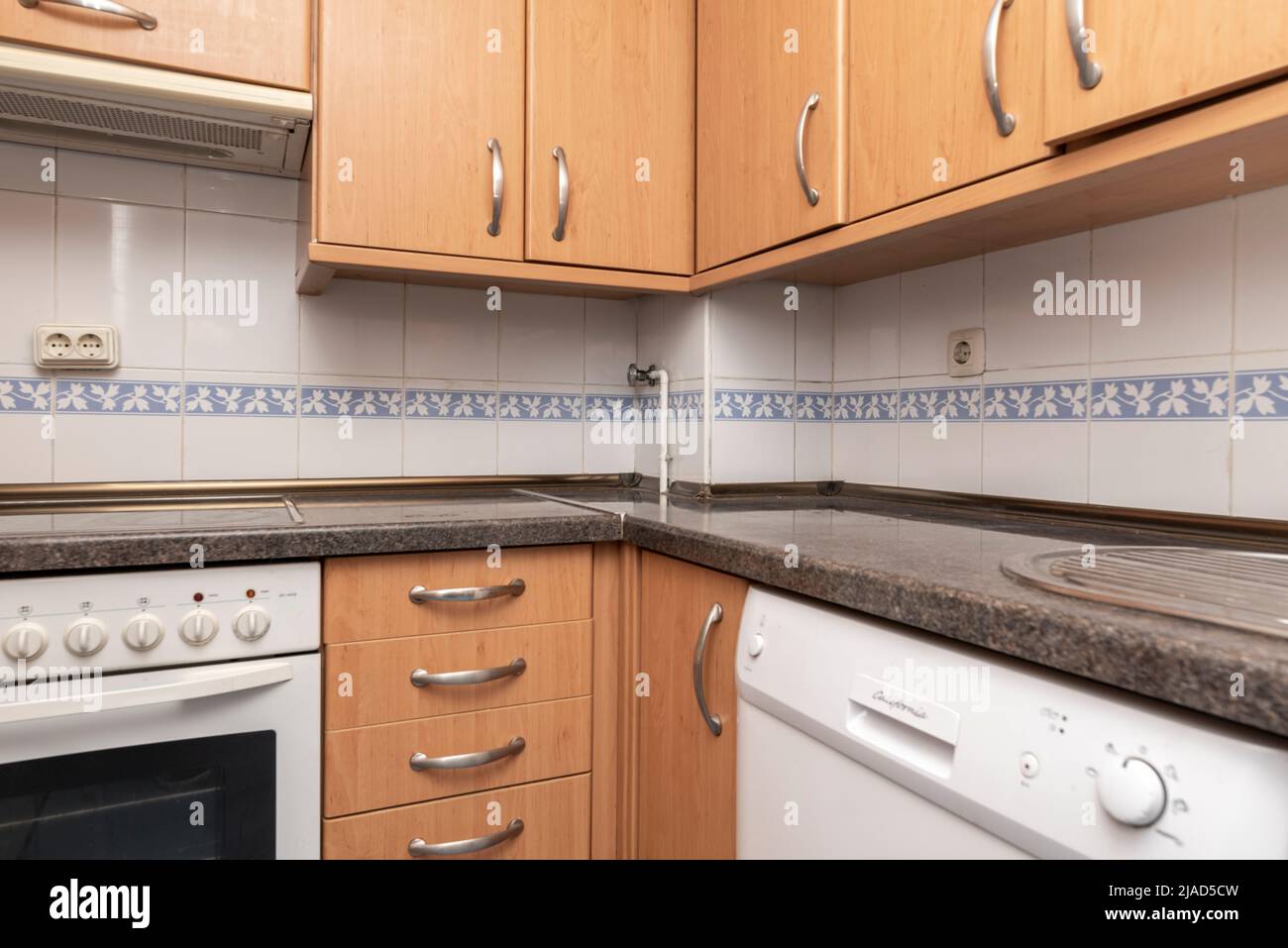 Picture of a kitchen with wood cabinets and matching drawers, reddish ...