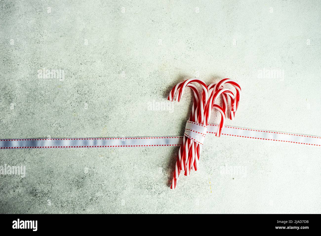 Bunch of striped candy cane sweets tied with a ribbon Stock Photo - Alamy