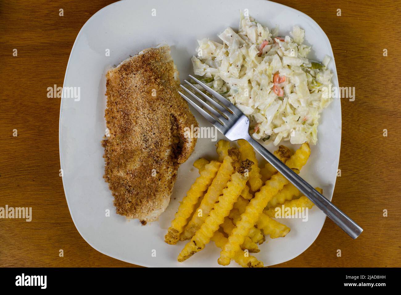 baked haddock served with cole slaw and fries Stock Photo - Alamy