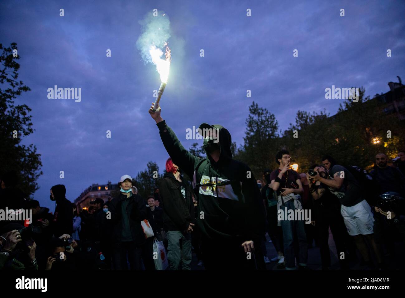 Protestor hold a bomb smoke during a protest in Paris Stock Photo - Alamy