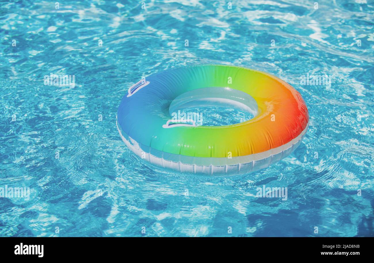 Pool float, ring floating in a refreshing blue swimming pool. Summer ...