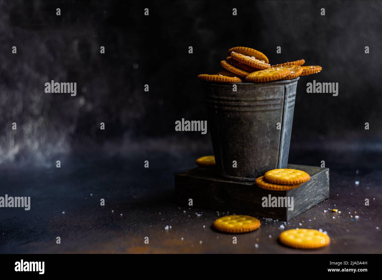 Salted cracker cookies in a metal bucket on a table Stock Photo - Alamy