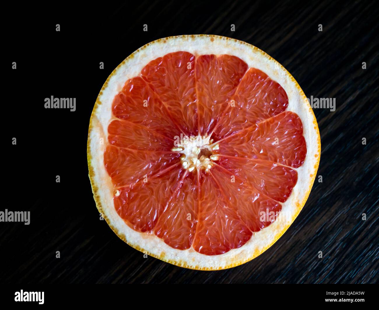 Sliced grapefruit on the dark background, cut grapefruit Stock Photo ...