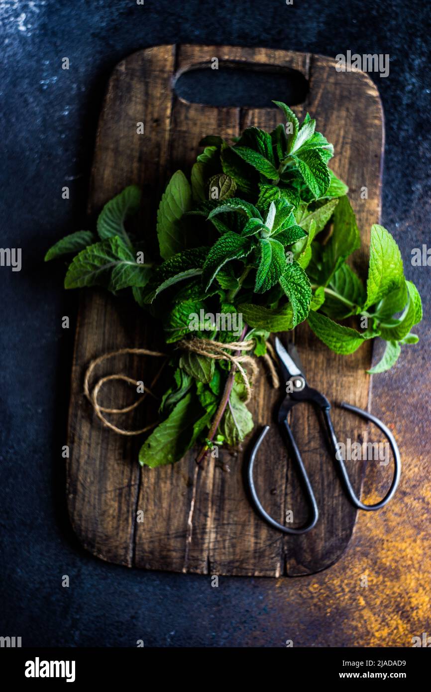 Overhead view of a bunch of fresh mint on a chopping board with ...