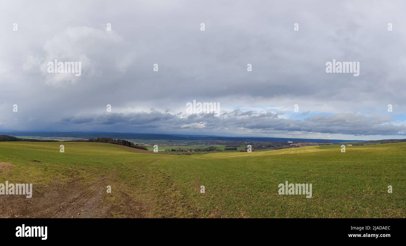 Panoramic landscape view of rolling hills, forests, and fields under ...