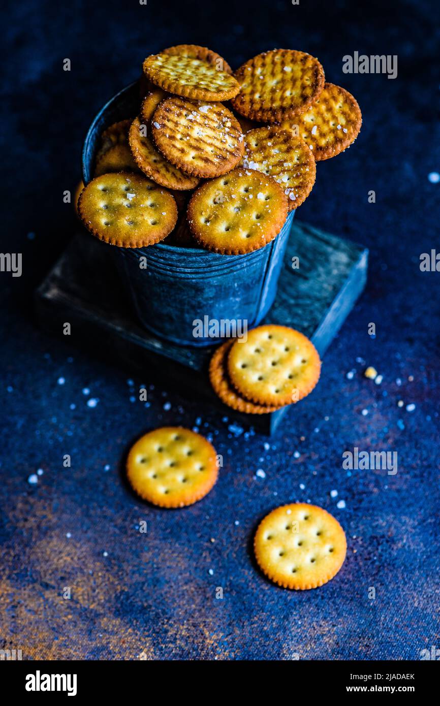 Salted cracker cookies in a metal bucket on a table Stock Photo - Alamy