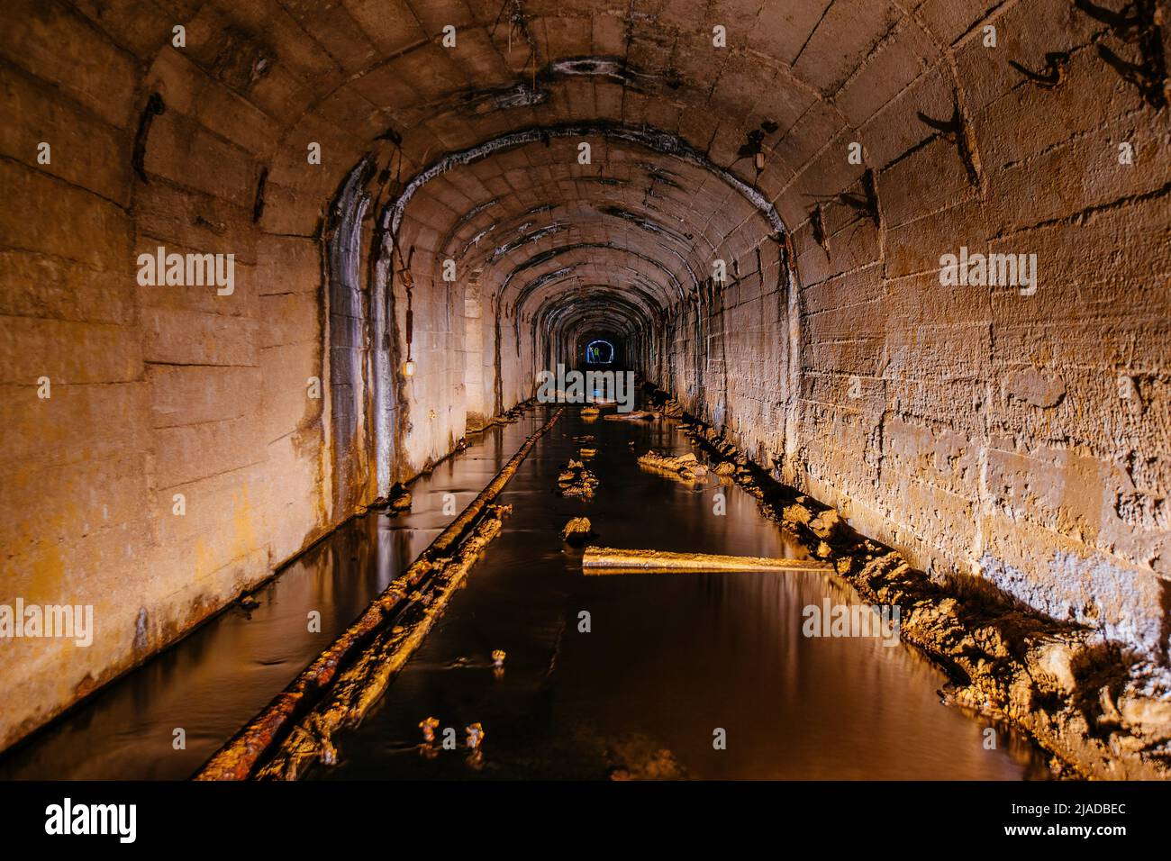 Dark flooded concrete vaulted mine tunnel Stock Photo - Alamy