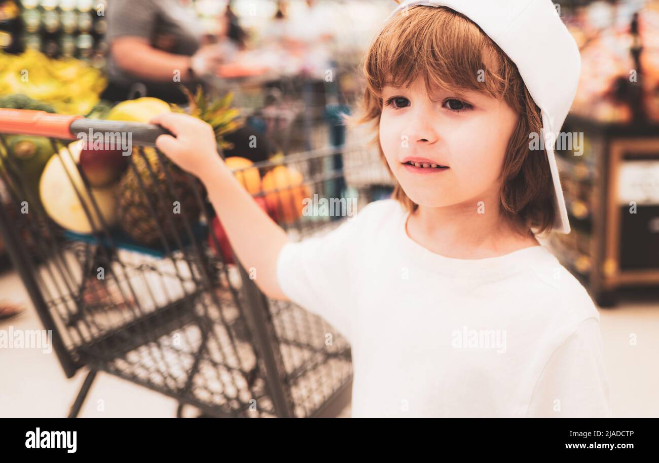 Sale, consumerism and people concept - happy little child with food in ...