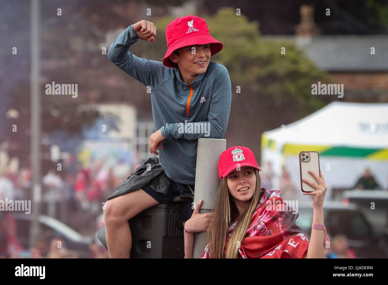 Supporters climb on a traffic light as the Liverpool FC squad celebrate ...