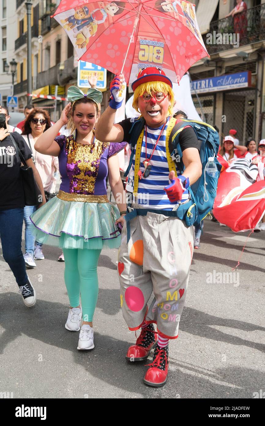 Two people of Peruvian origin dress as clowns during a parade to ...