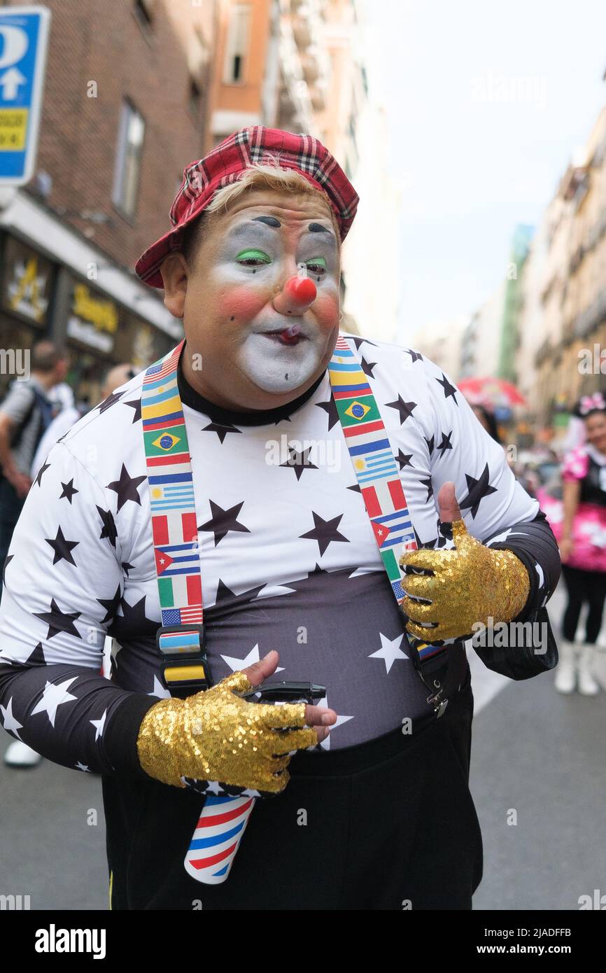 A man of Peruvian origin dresses as a clown during a parade to ...