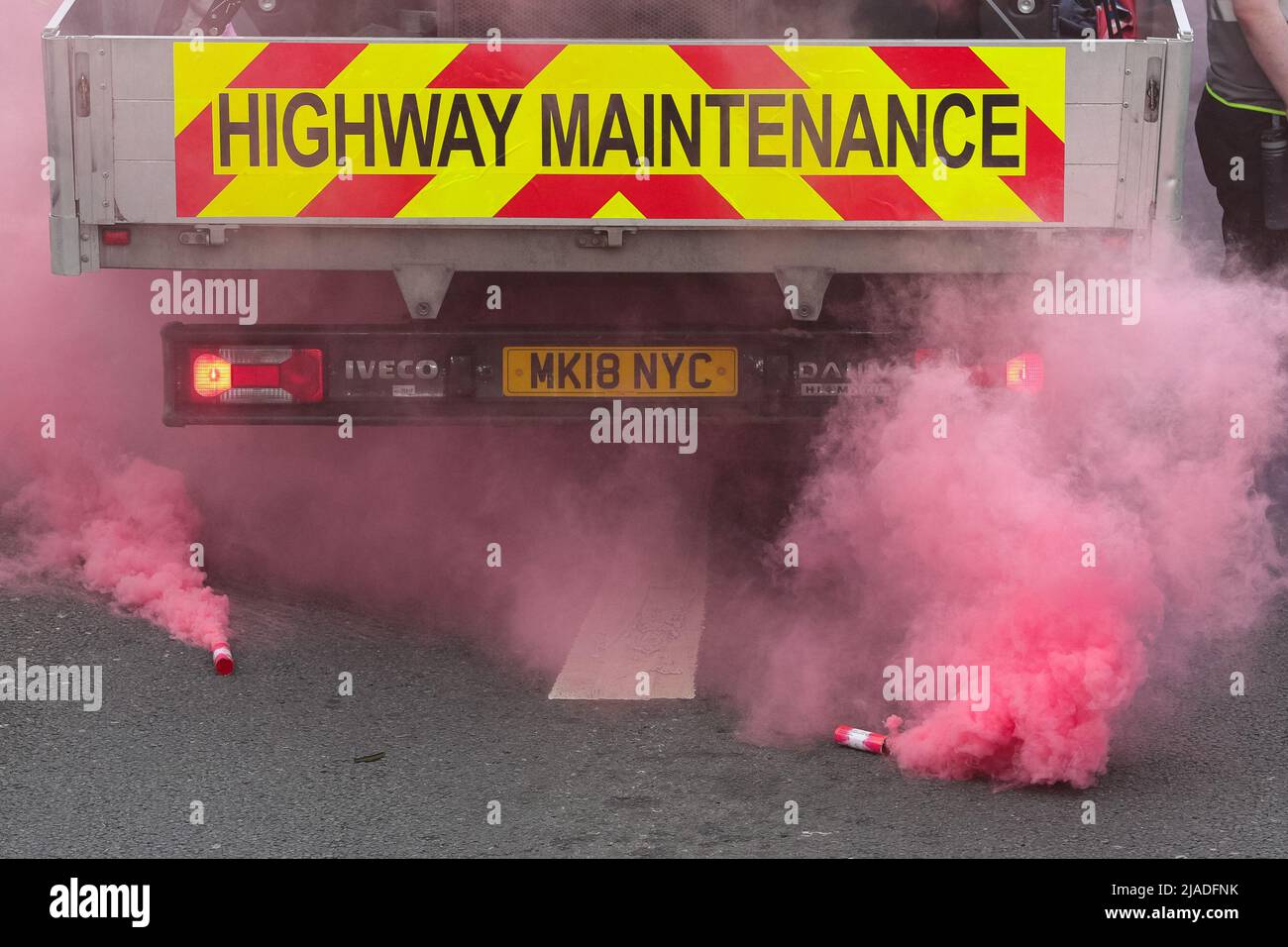 Flares are thrown on the road as the Liverpool FC squad celebrate ...