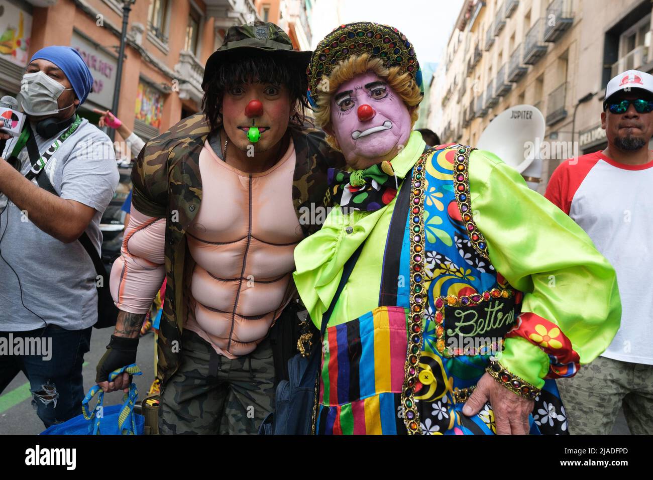 Two men of Peruvian origin dress as clowns during a parade to celebrate ...