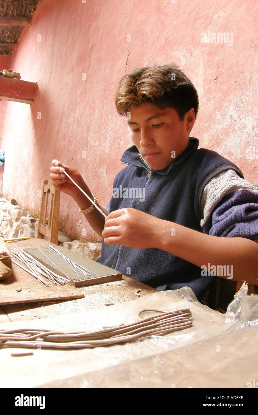 Peruvian peasant craftsmen, making beads and small clay handicrafts ...