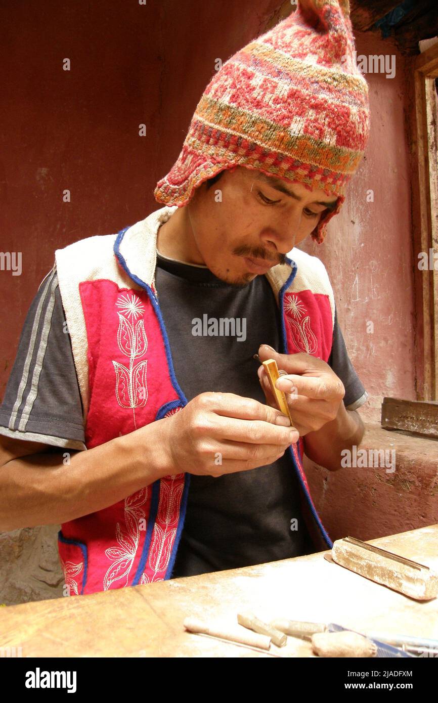 Peruvian peasant craftsmen, making beads and small clay handicrafts ...