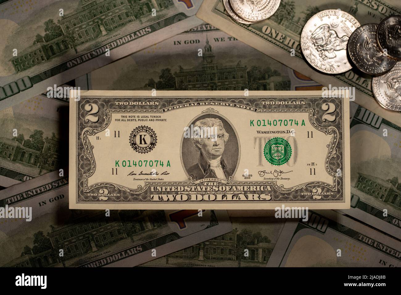 2 Dollar banknote on top of different denominated USD banknotes. Rare ...