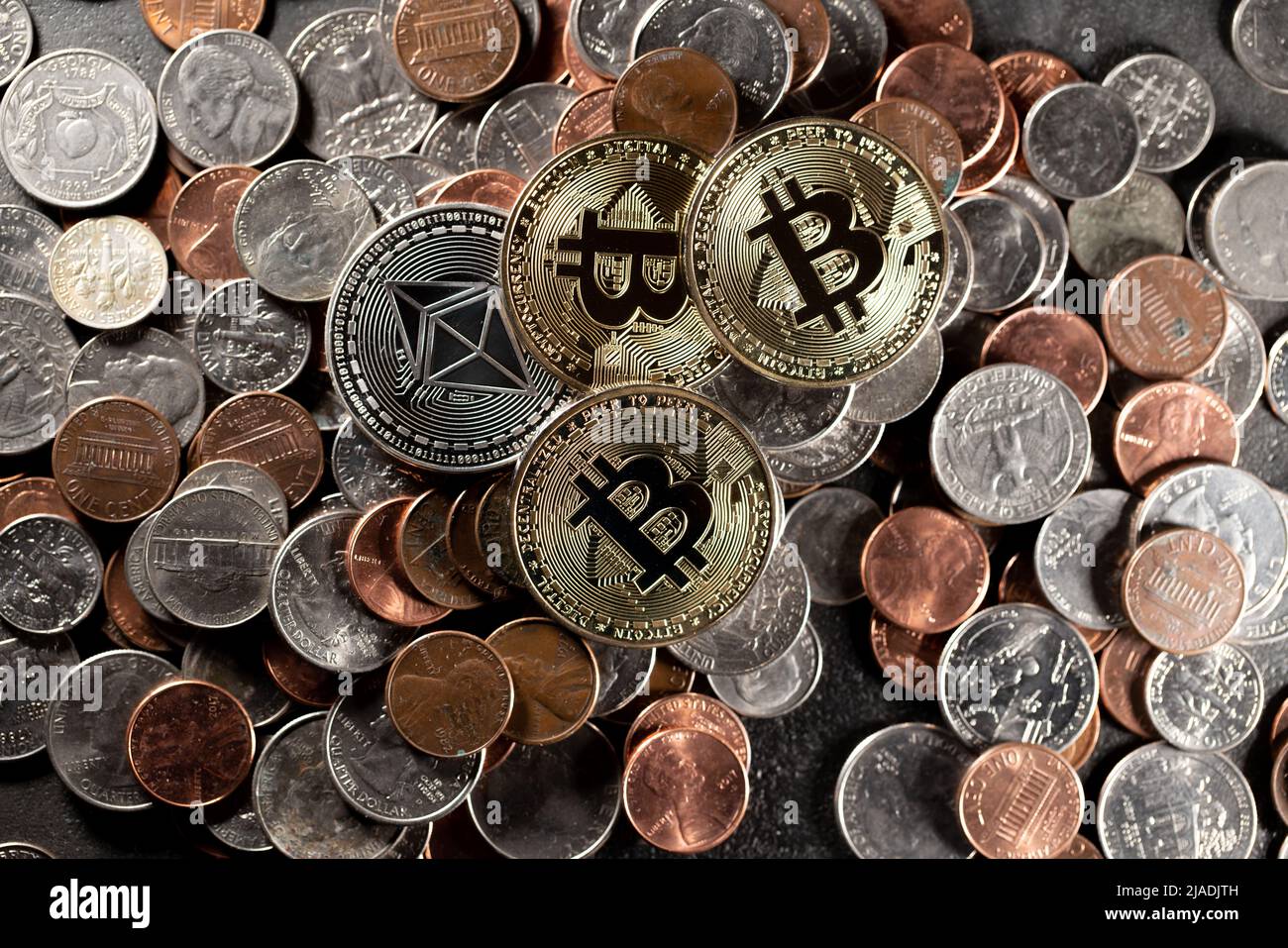 Piled up US dollar coins peaking Bitcoin and Ethereum coins. Background ...