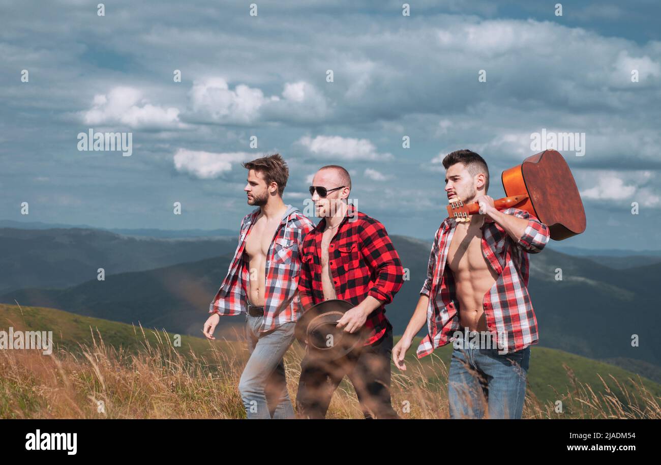 Three happy friends are looking on mountains and having fun together ...