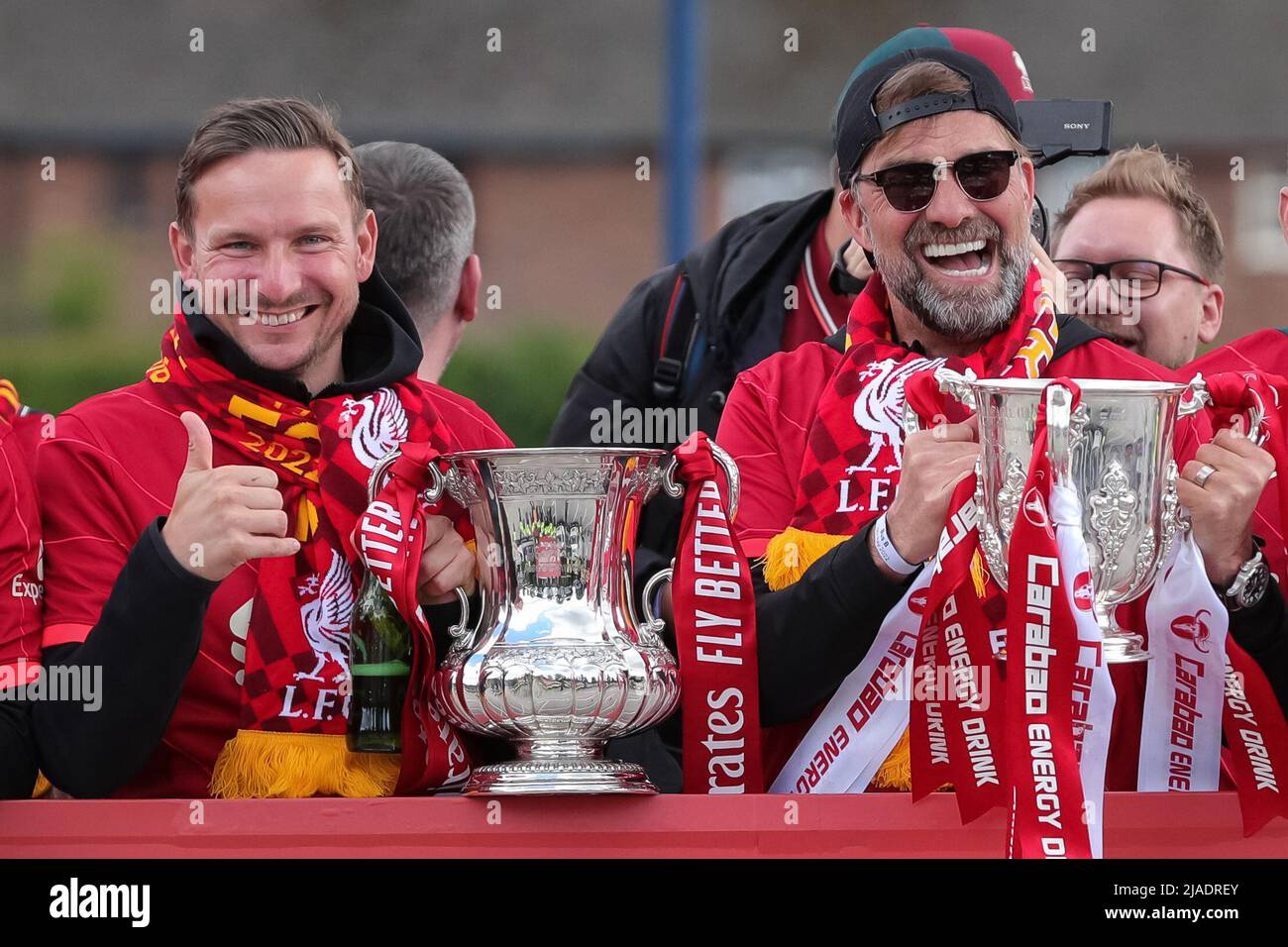 Jürgen Klopp manager of Liverpool and his coaching staff hold up the Carabao Cup and the FA Cup ...