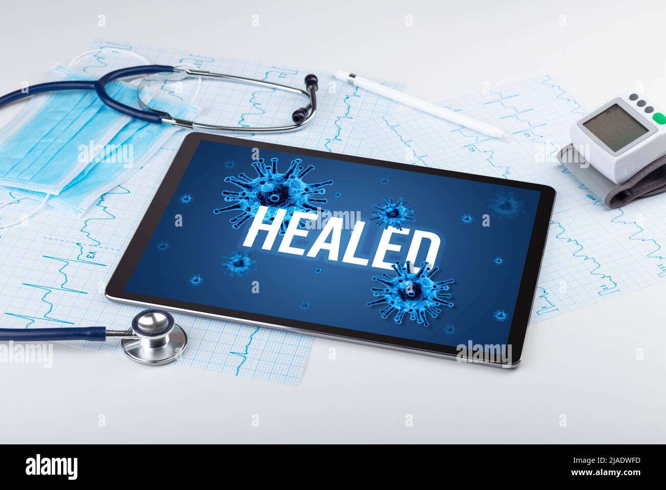 Tablet pc and doctor tools on white surface Stock Photo - Alamy
