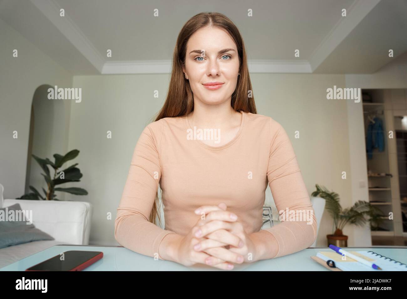 Portrait of young woman talking to camera making video conference Stock ...