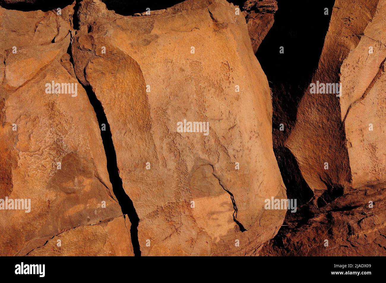 Ancient rock paintings on a flat red stone close-up. Chests, Khakassia ...