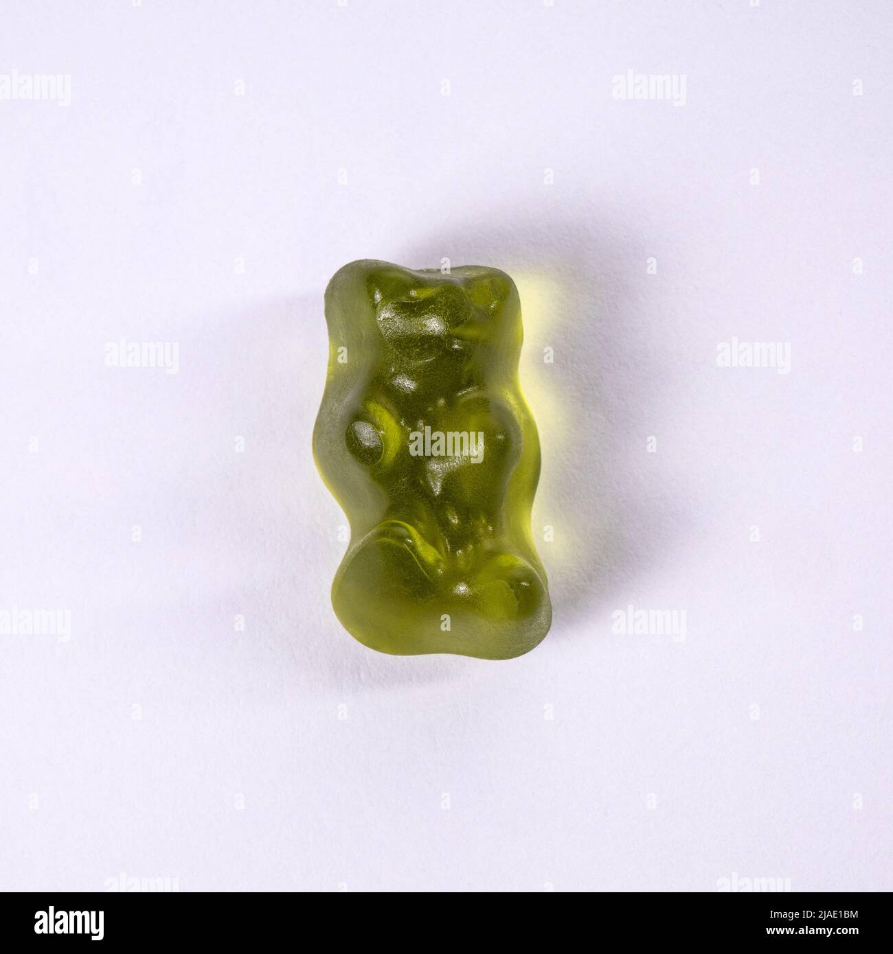 Green rubber bear candy on a white background Stock Photo - Alamy