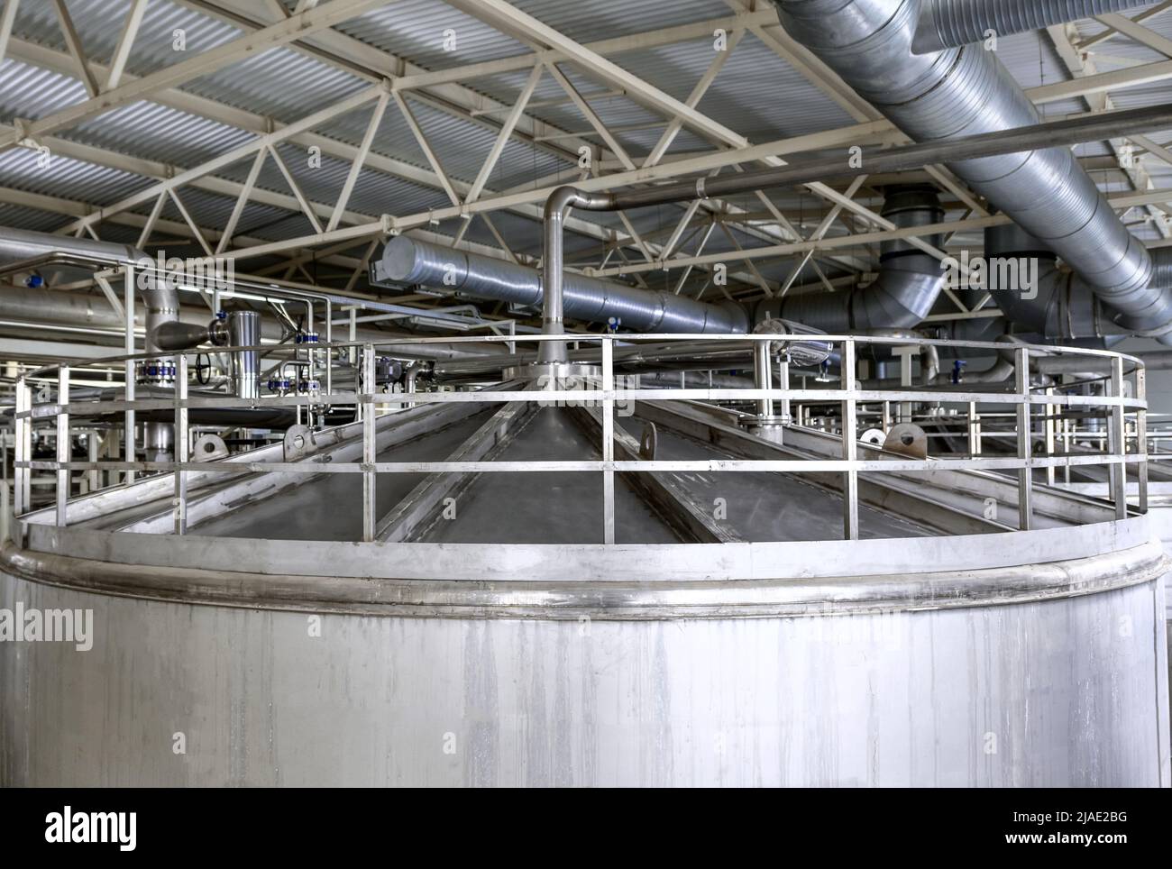 Container with railing on top and connected pipe at plant Stock Photo ...