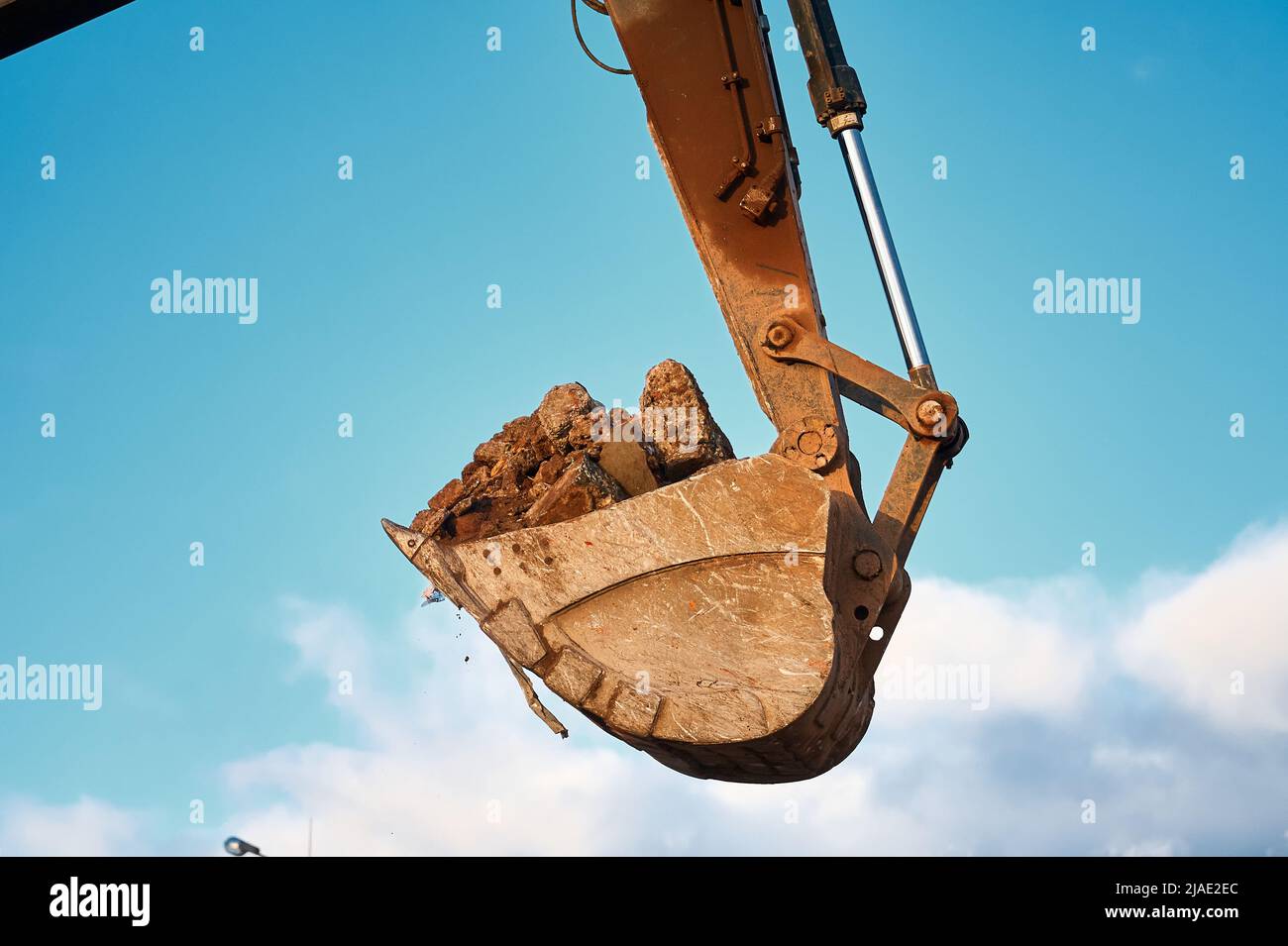 Scoop of building excavator full of concrete stone leftovers Stock Photo - Alamy