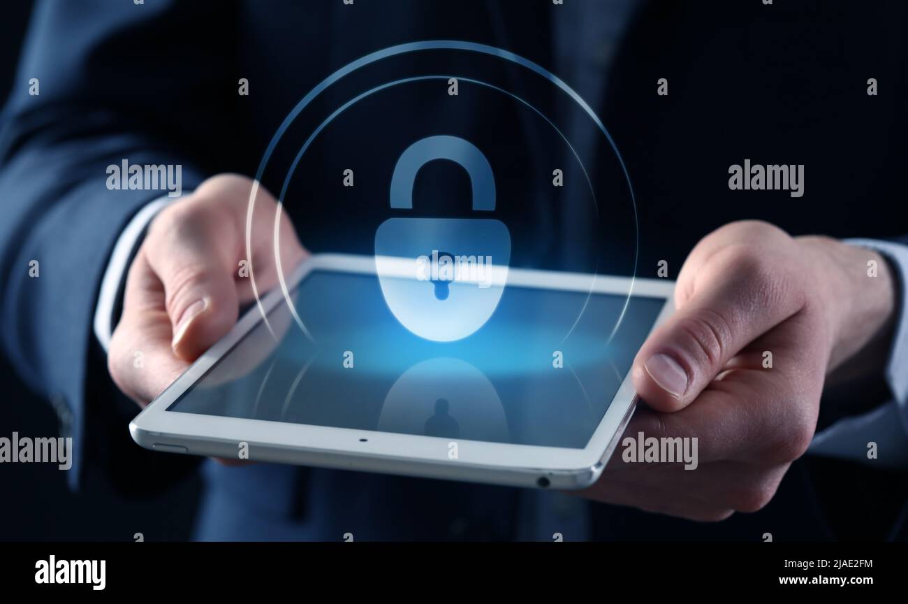 Businessman with tablet computer and lock on virtual screen, closeup ...