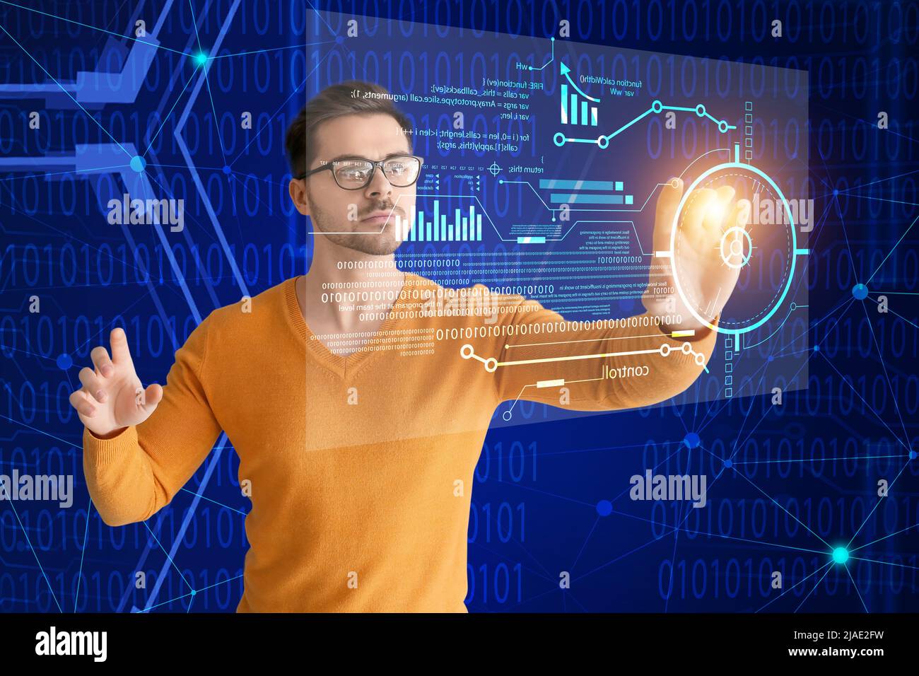 Male programmer using virtual screen on blue background Stock Photo - Alamy